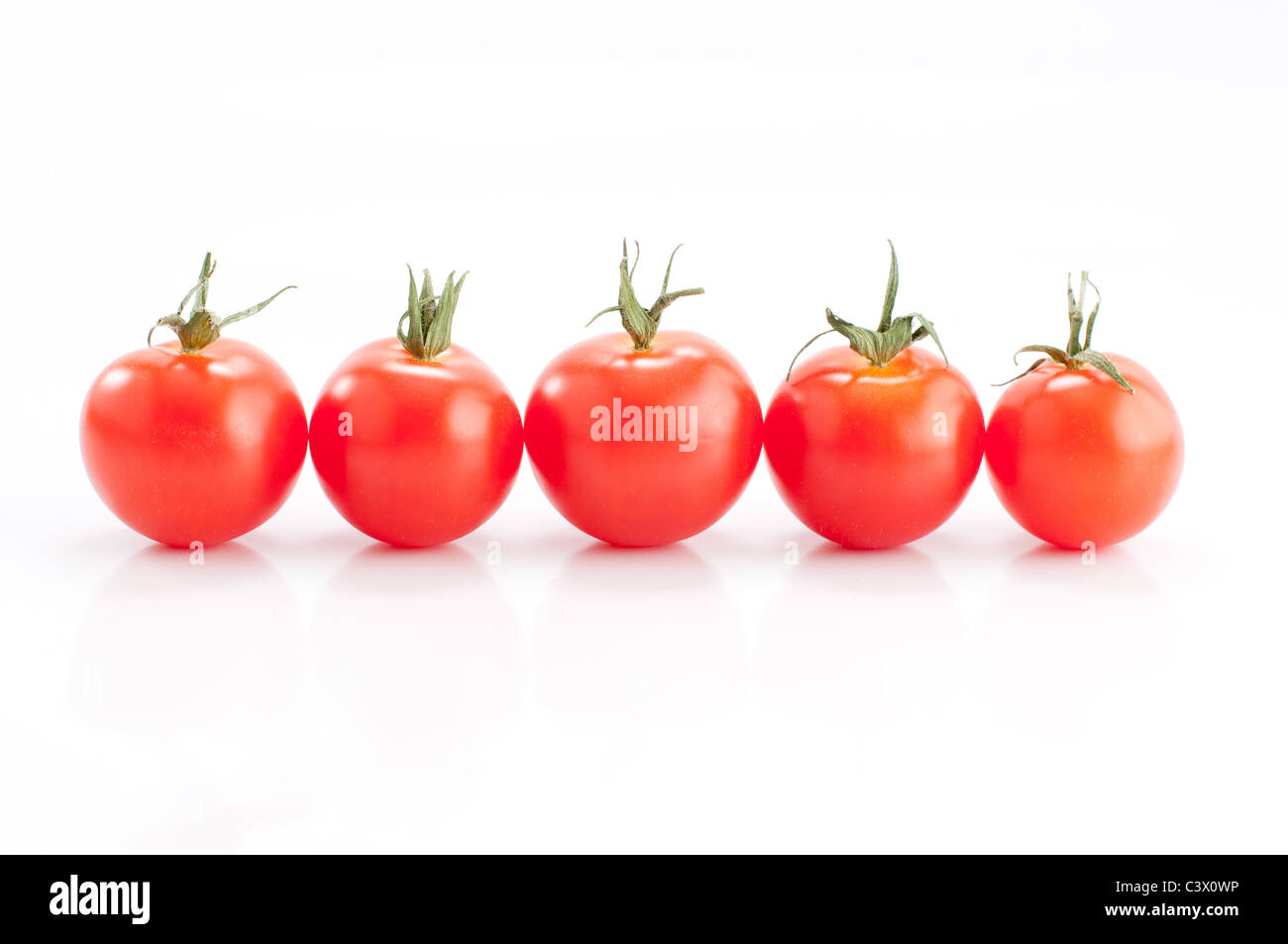 Five Fresh Mini Tomatoes, over white background Stock Photo - Alamy