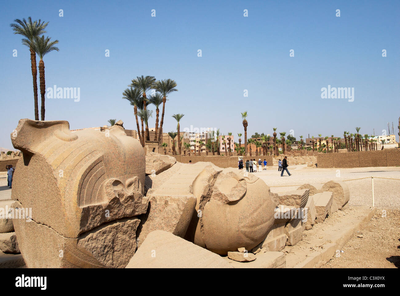 Broken statues at Luxor Temple Stock Photo - Alamy