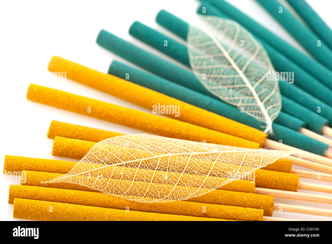 Green and yellow incense on white background Stock Photo - Alamy