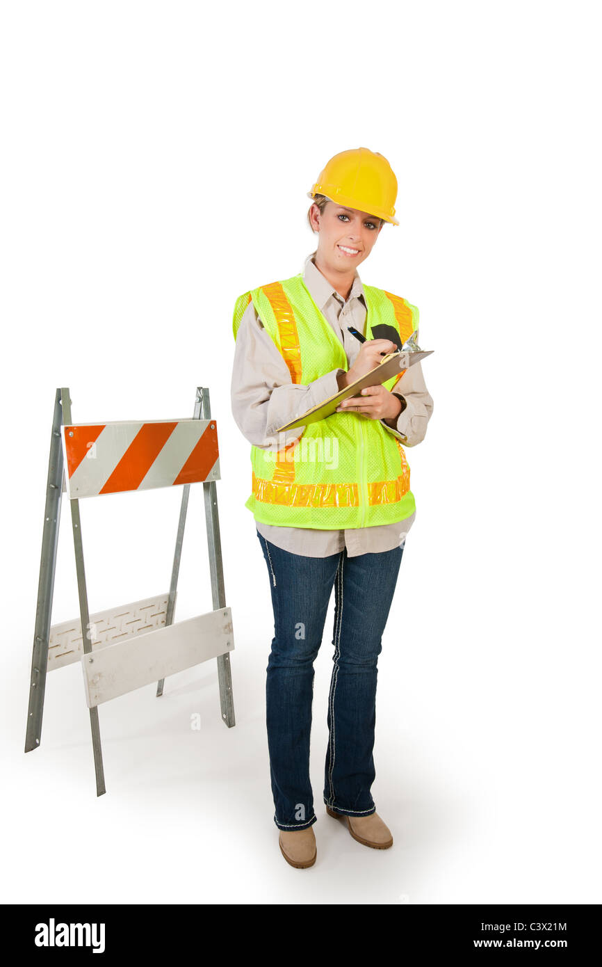 a young female construction worker filling out her paperwork using a ...