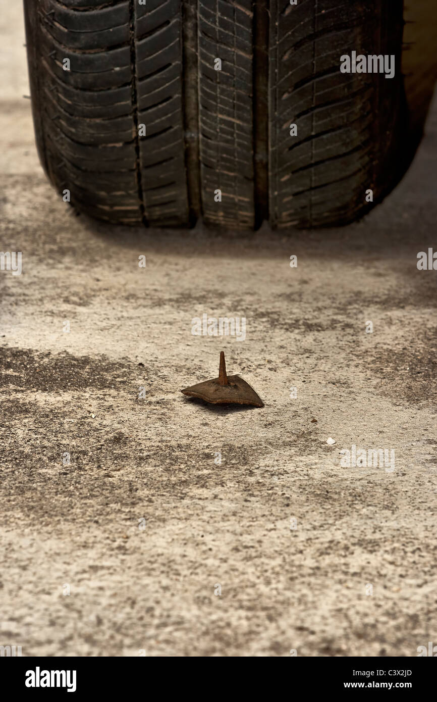 danger on road, driving concept with tyre and nail Stock Photo - Alamy