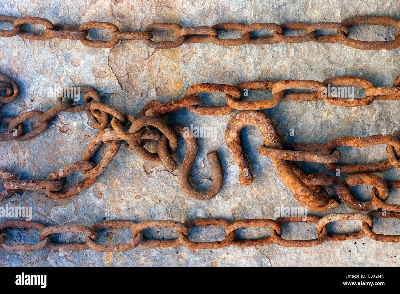 rusty chain with hook over stone background Stock Photo - Alamy