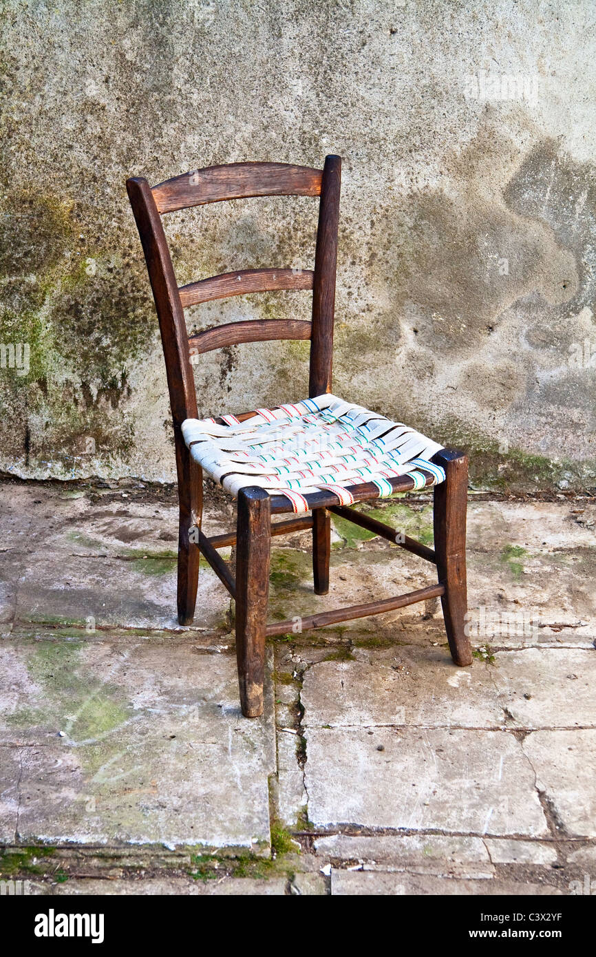 old single chair in a grungy background Stock Photo - Alamy