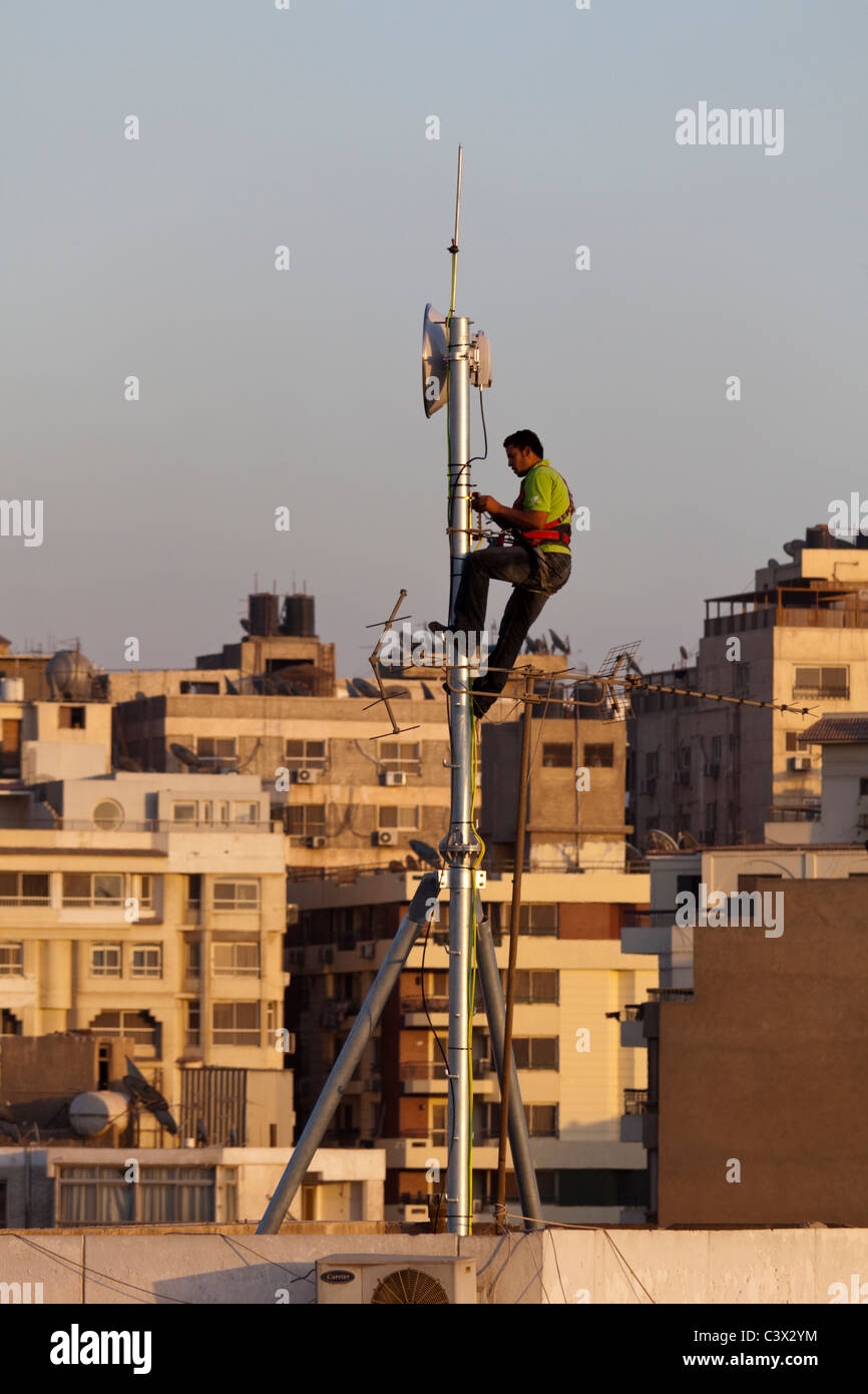 Workman fixing aerial antenna on hi-res stock photography and images ...