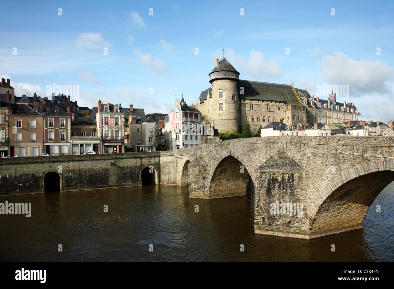 View of Chateau de Laval and ancient stone arched bridge crossing the ...