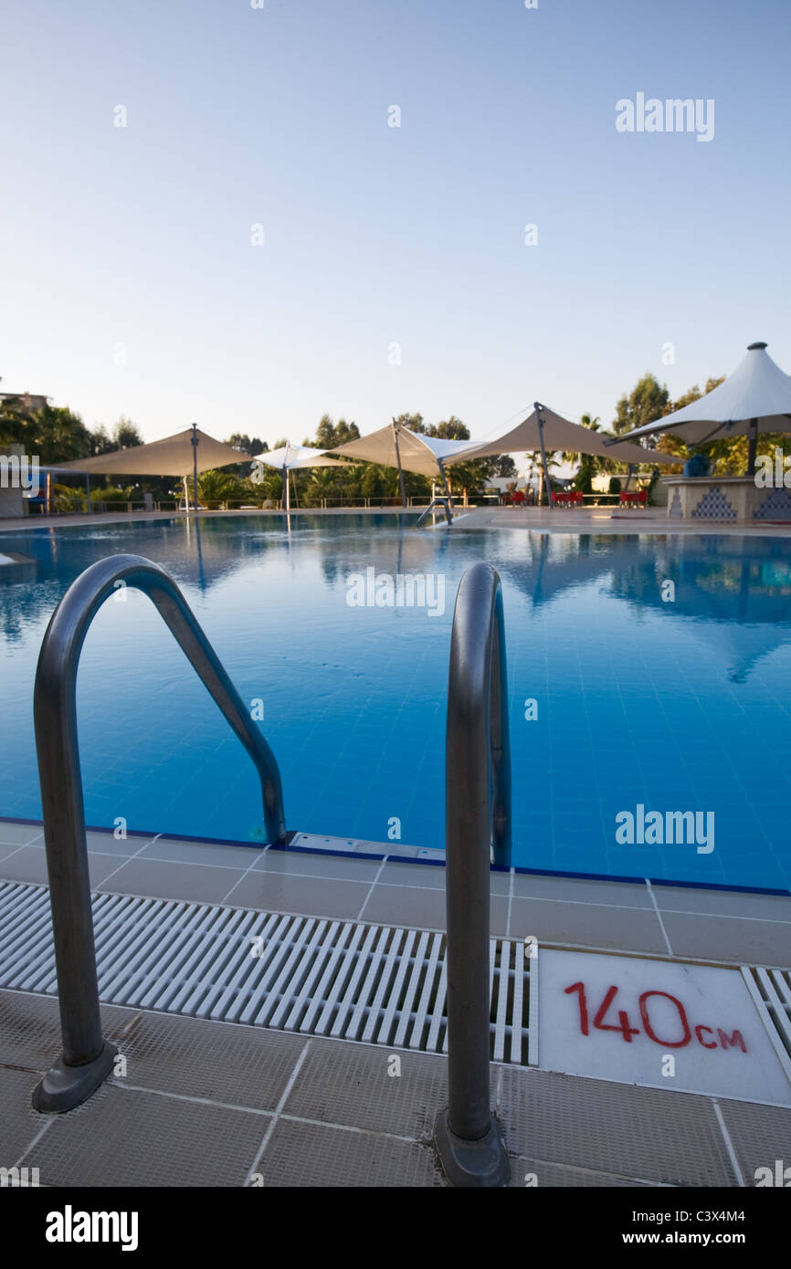 Swimming pool in early morning, beach bar on background Stock Photo - Alamy