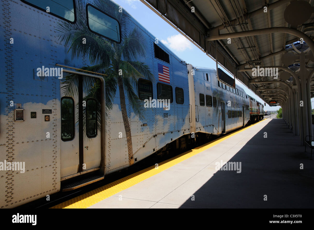 Tri Rail train painted with palm tree US flag and blue sky on the ...