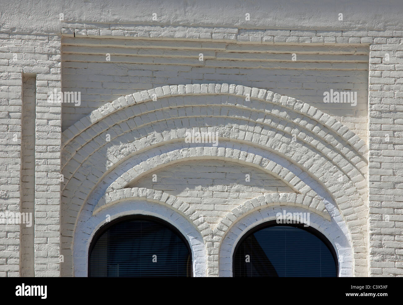 Two windows with round construction Stock Photo - Alamy