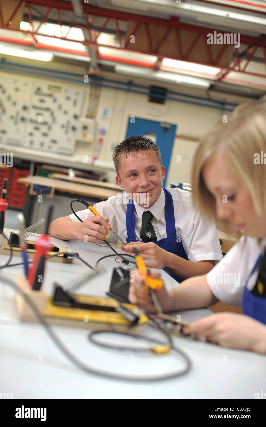 a school girl and boy in a design technology lesson GCSE in a classroom ...