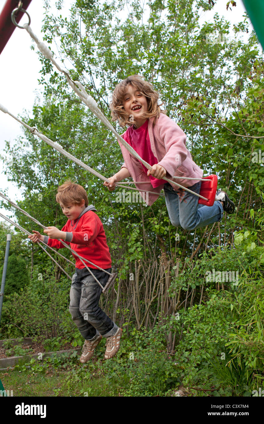 children on a swing Stock Photo - Alamy