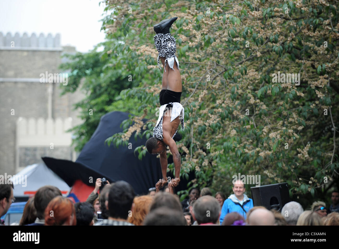 Acrobats in action above the watching crowd at The Fringe City street ...