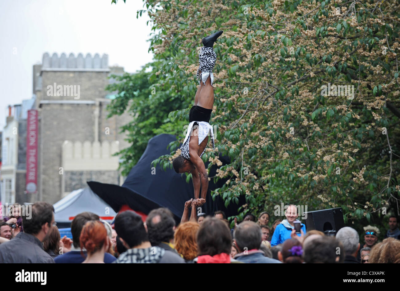 Acrobats in action above the watching crowd at The Fringe City street ...
