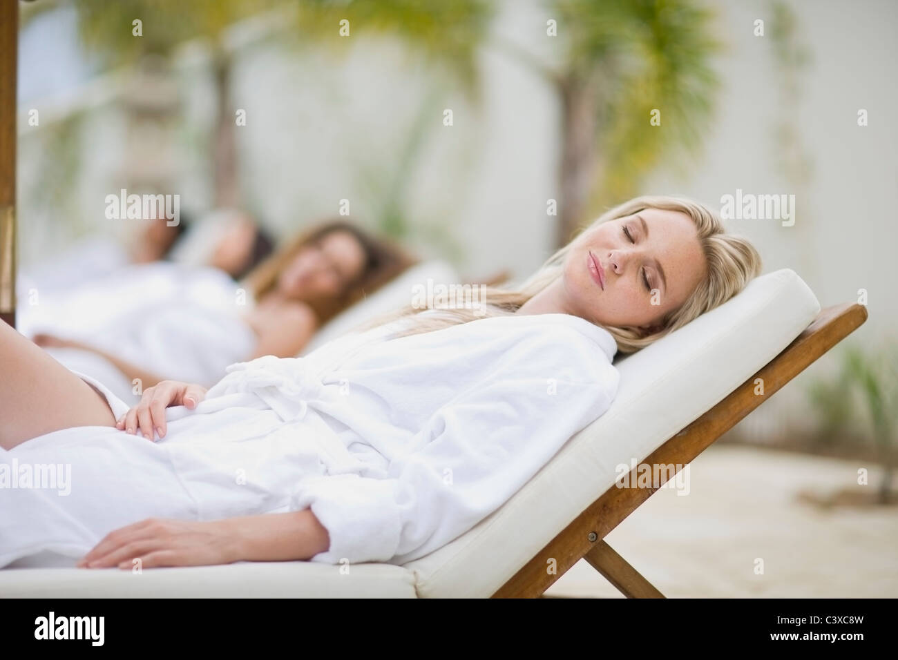 Woman sleeping on lounge chair hi-res stock photography and images - Alamy