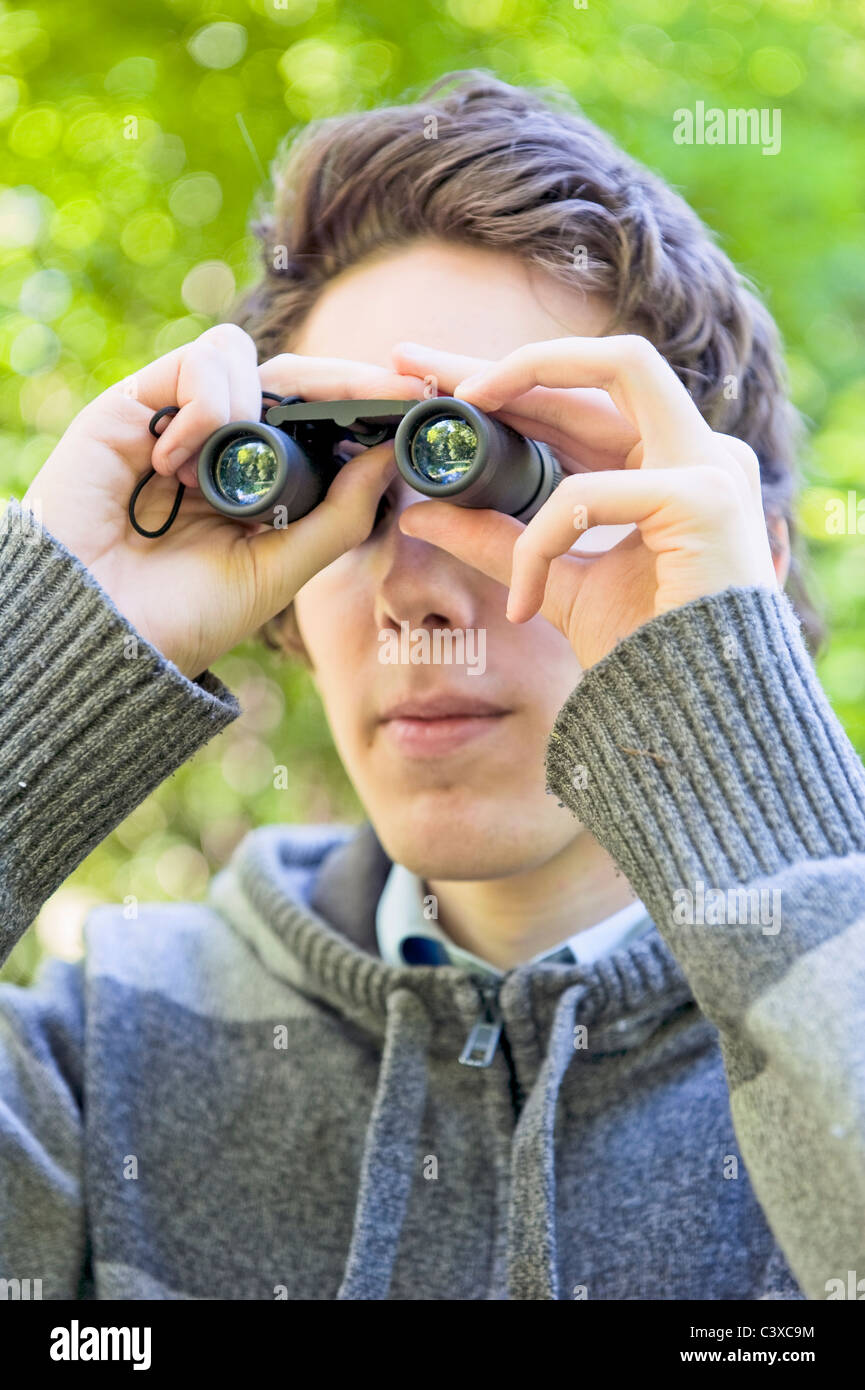 Young man birdwatching Stock Photo - Alamy