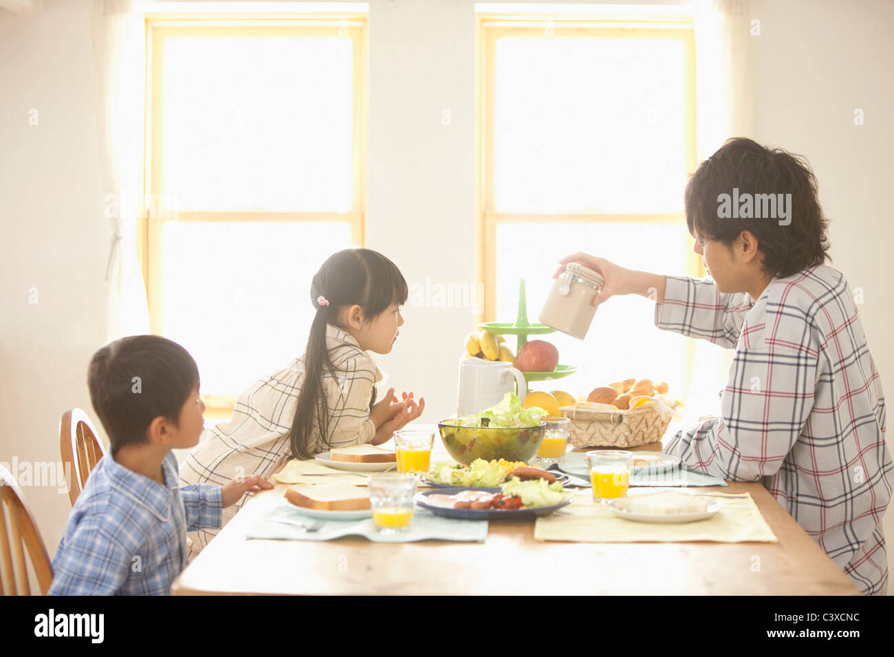 Father and Two Children at Breakfast Table Stock Photo - Alamy