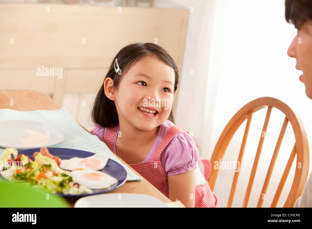 Daughter Talking to Father at Breakfast Table Stock Photo - Alamy