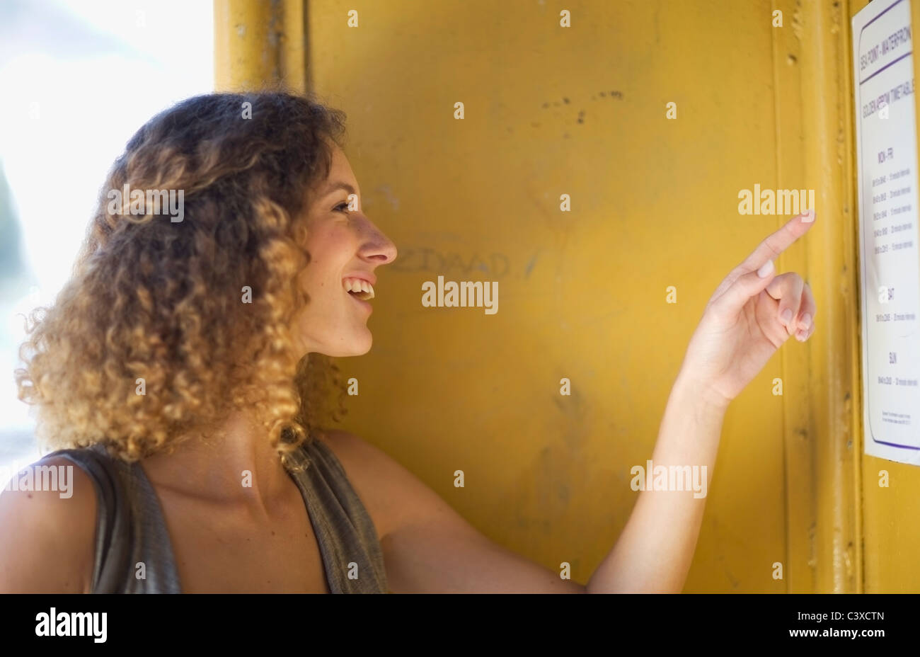 Woman checking a time table Stock Photo - Alamy