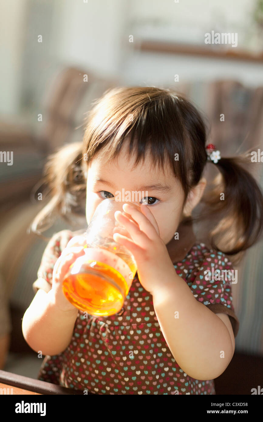 Baby Girl Drinking Juice Stock Photo - Alamy
