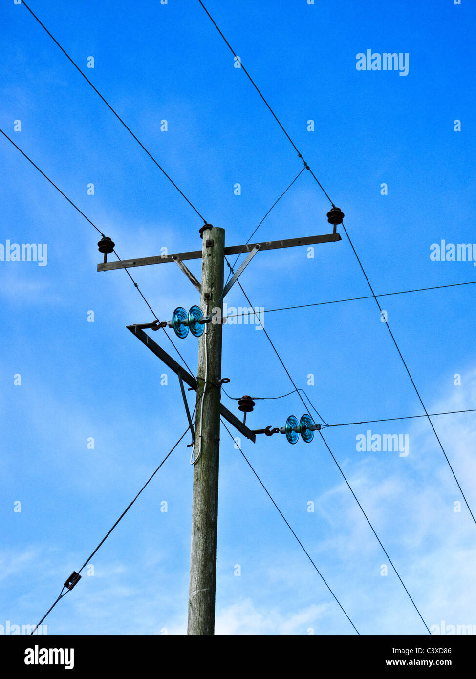 Telegraph pole against a blue sky Stock Photo - Alamy