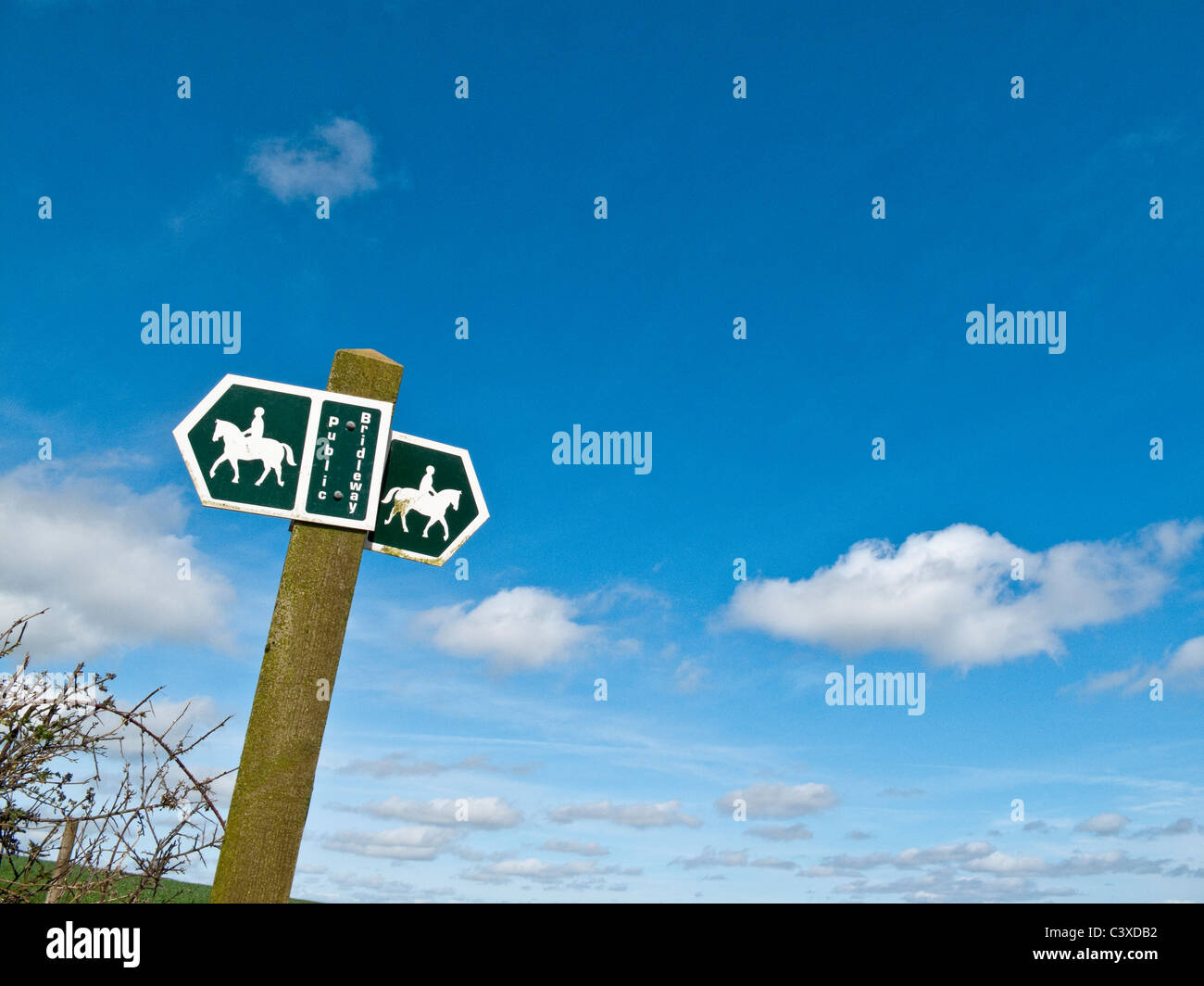 Landscape photo of Public Bridleway sign with blue sky and white clouds ...