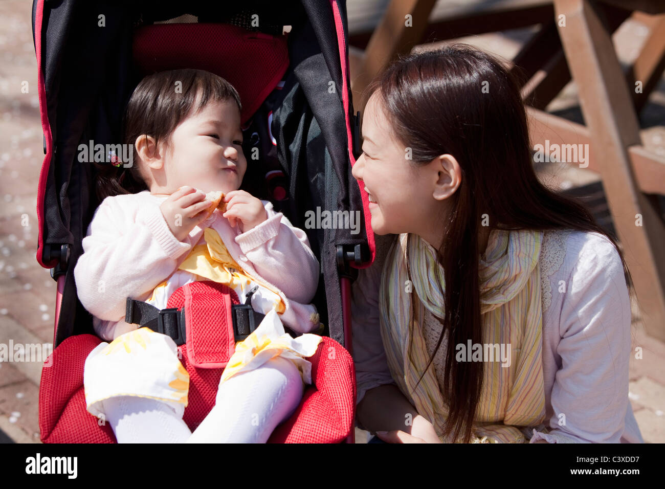 Young Woman Looking at Baby Girl Stock Photo - Alamy