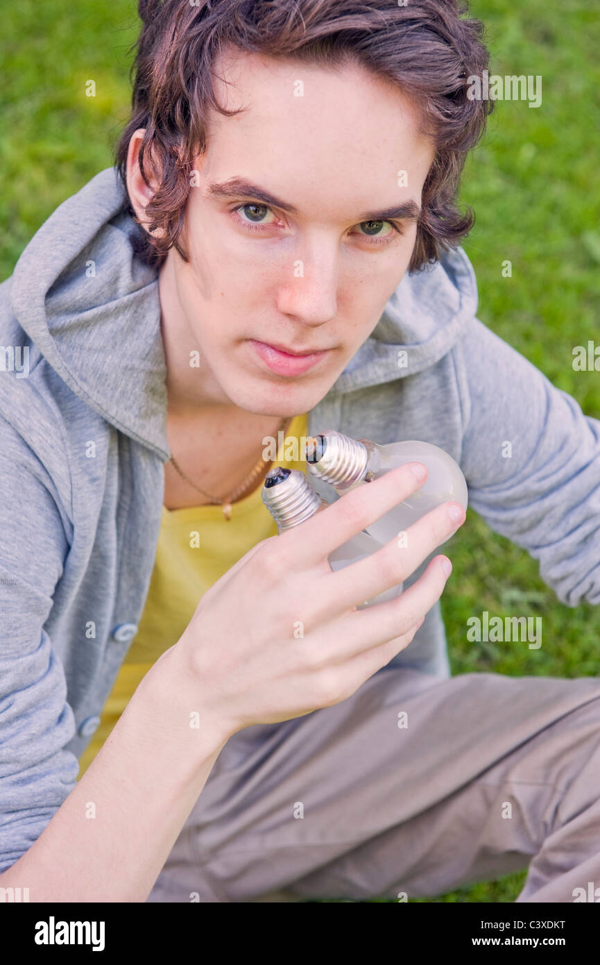 Young man holding lightbulbs Stock Photo - Alamy