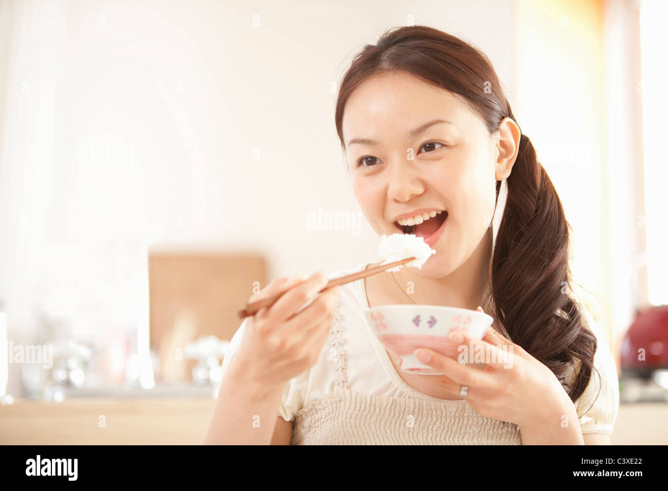 Young Woman Having Rice Stock Photo - Alamy