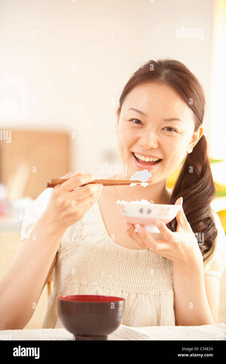 Young Woman Eating Rice Stock Photo - Alamy