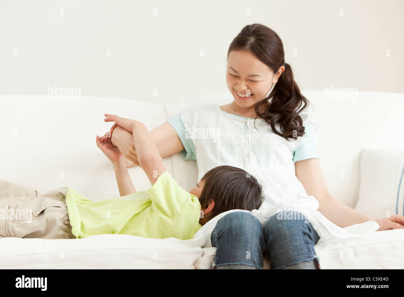 Boy Resting Head on Mother's Lap Stock Photo - Alamy