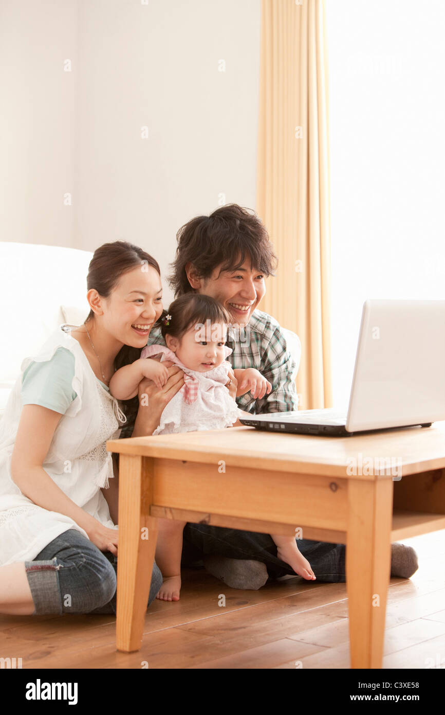 Parents and Baby Girl Using Laptop Stock Photo - Alamy