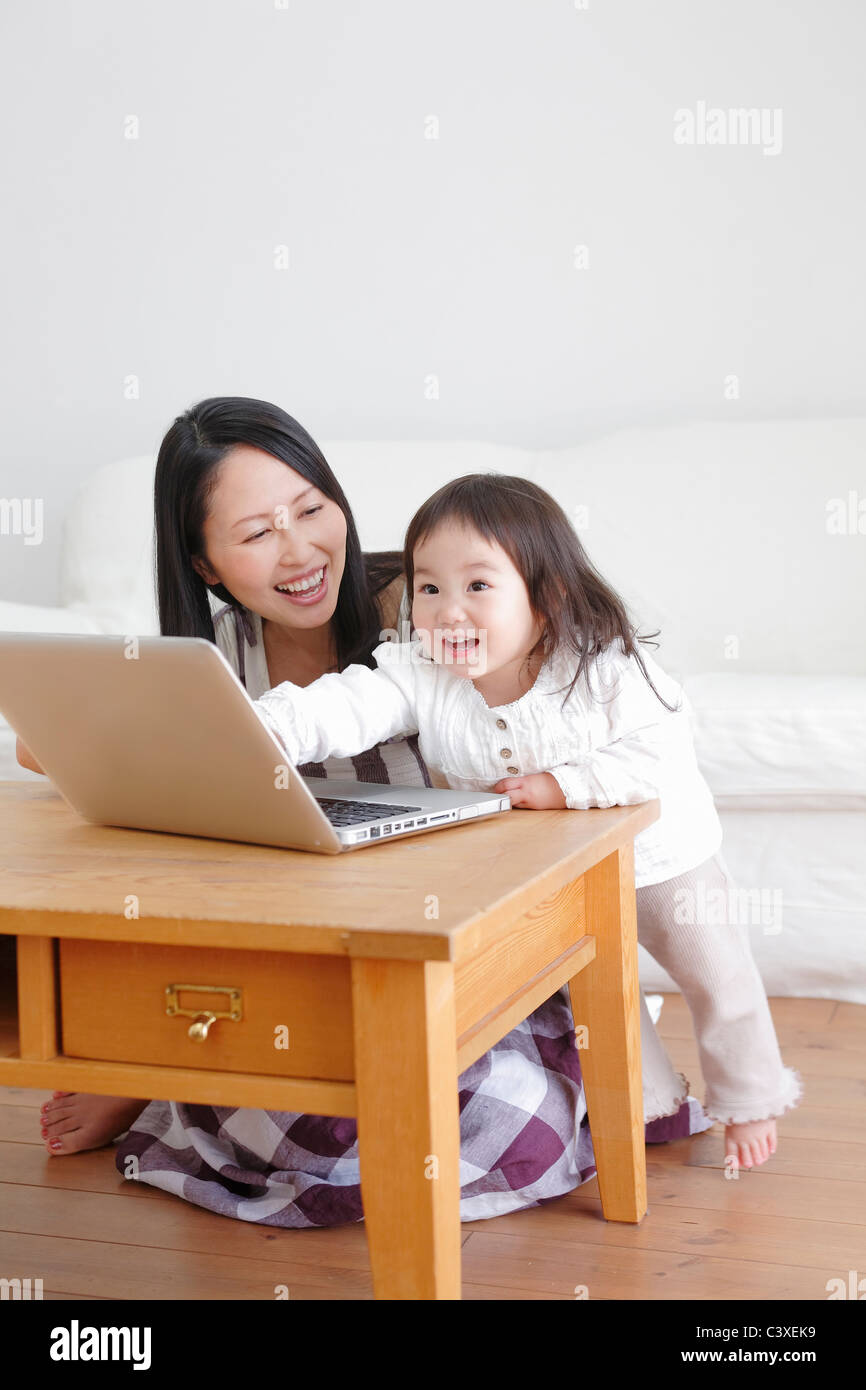 Mother and Baby Girl Using Laptop Stock Photo - Alamy