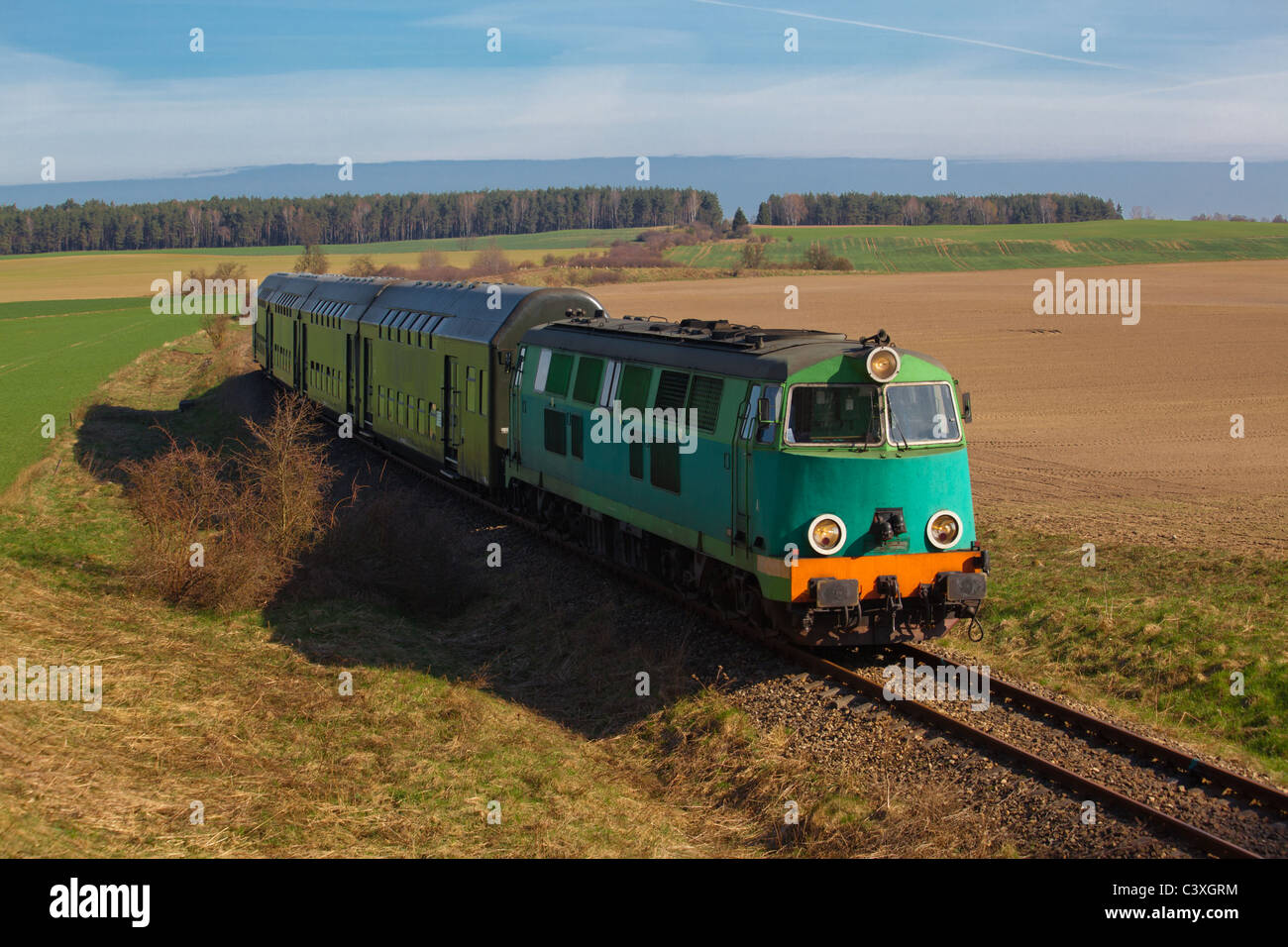 Passenger train passing through countryside Stock Photo - Alamy