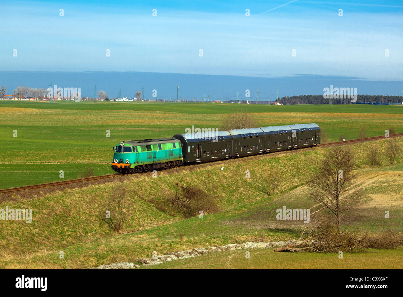 Passenger train passing through countryside Stock Photo - Alamy