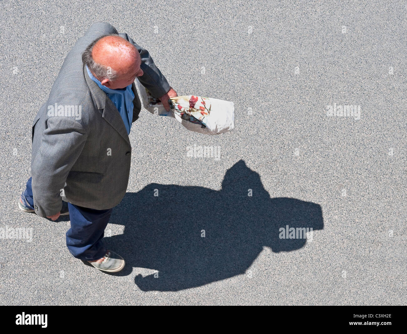 Overhead view of man walking along street - France Stock Photo - Alamy