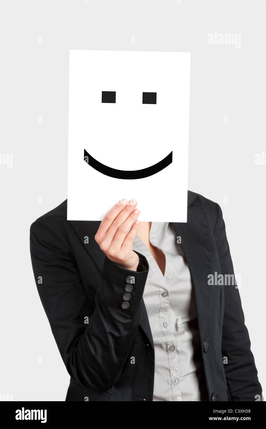 Woman showing a blank paper with a smile in front of her face Stock ...