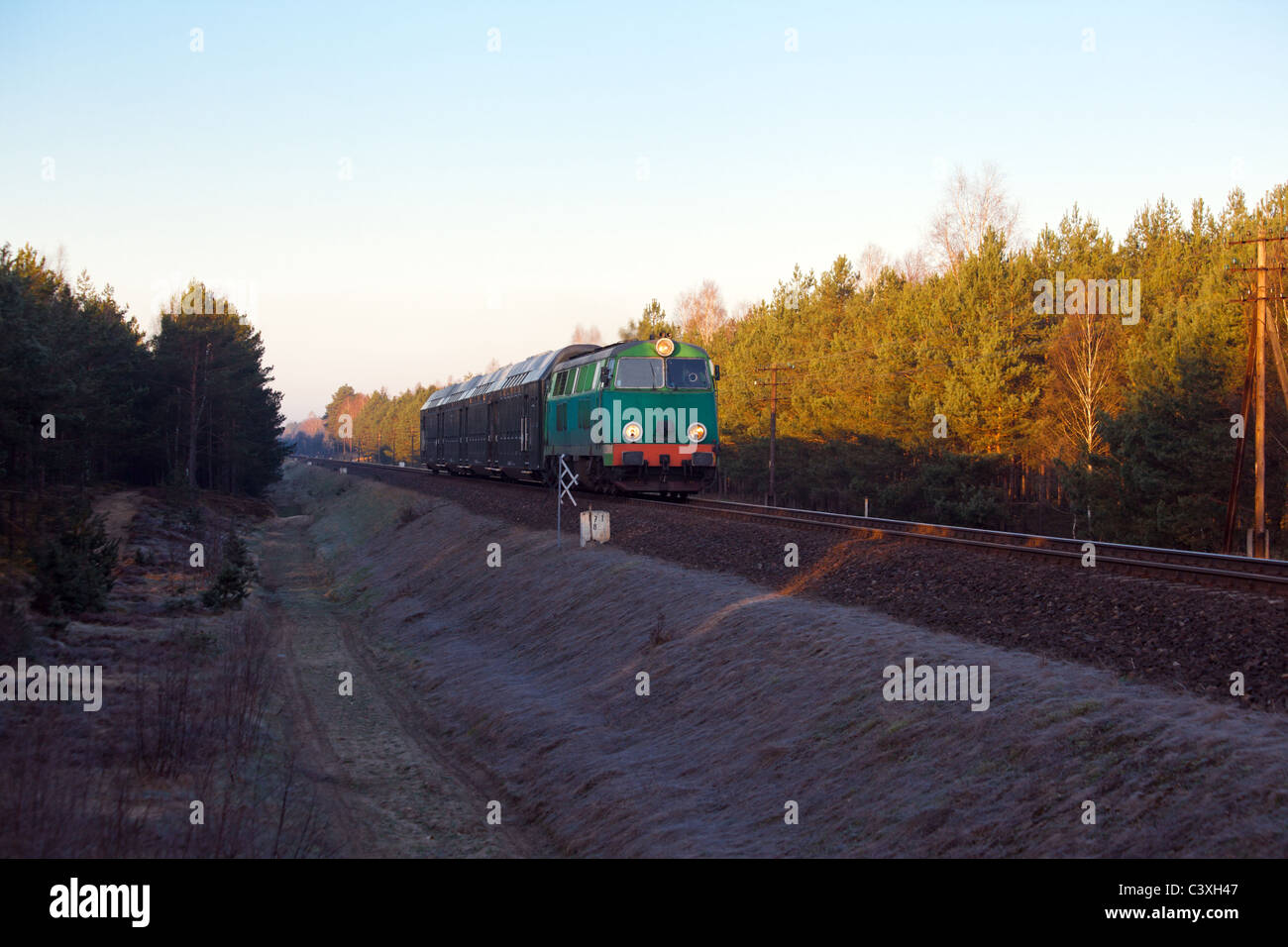 Passenger train passing through countryside Stock Photo - Alamy
