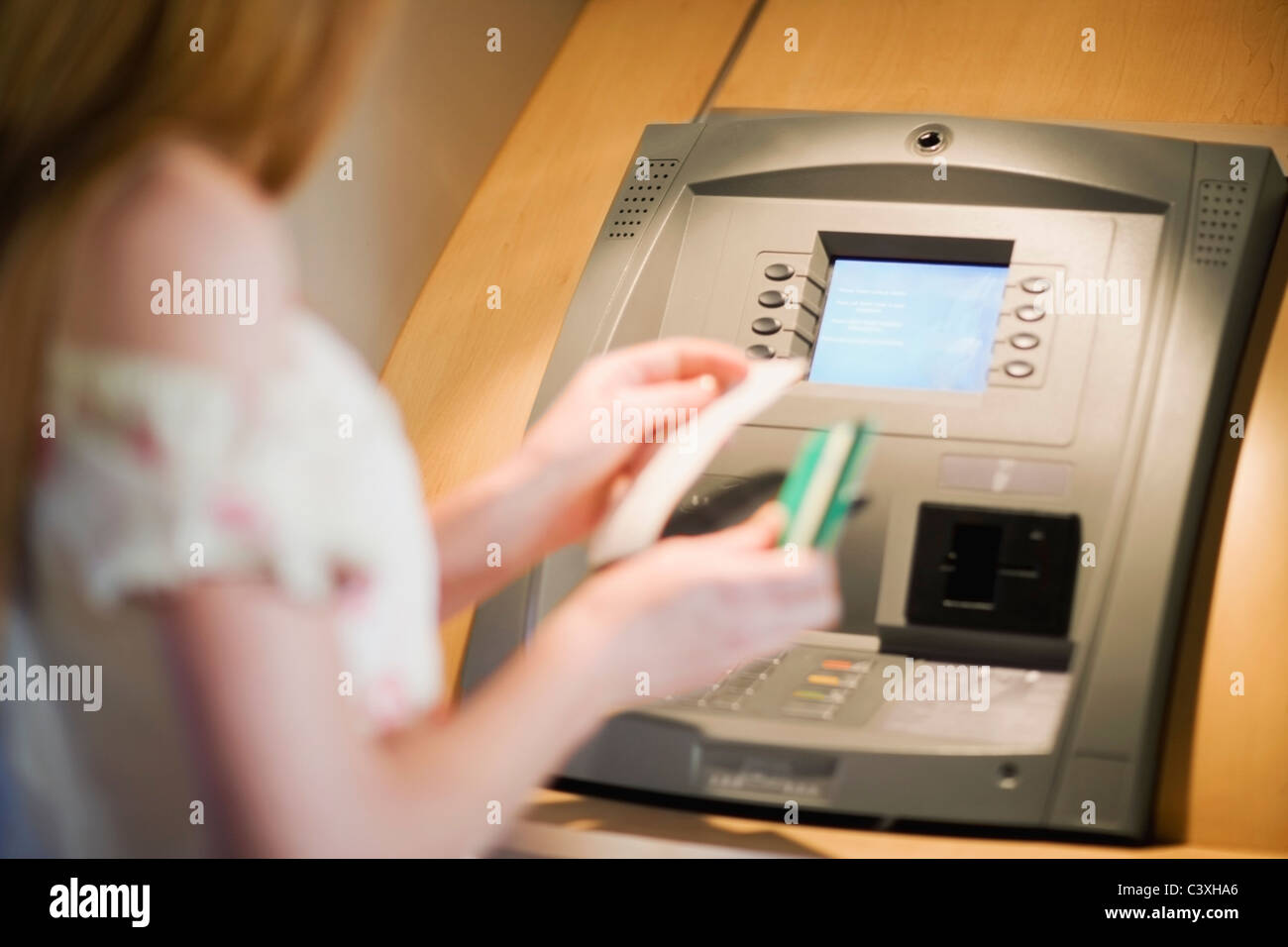 Woman at a cashpoint Stock Photo - Alamy