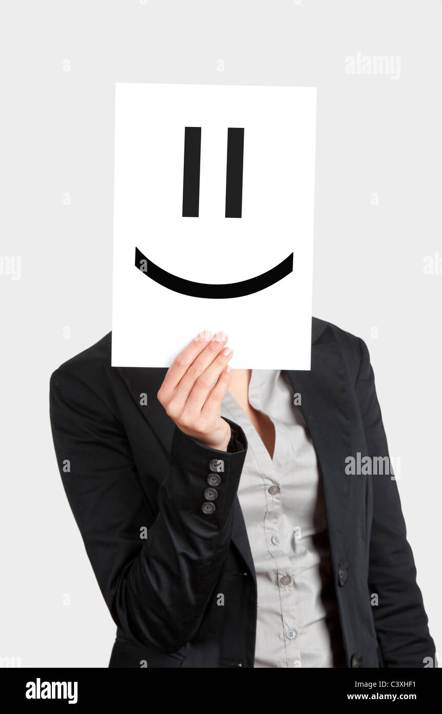 Woman showing a blank paper with a smile in front of her face Stock ...