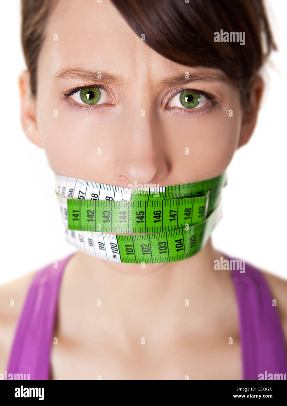 Portrait of a young woman with a green measuring tape covering the ...