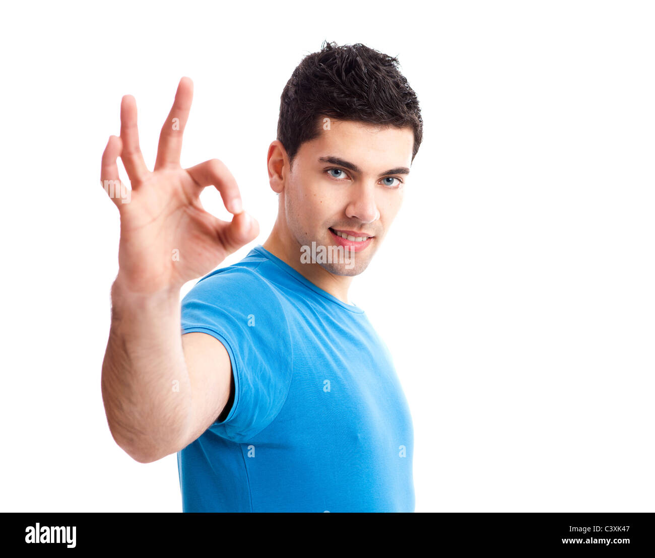 Portrait of a smiling handsome young man gesturing ok sign over a white ...