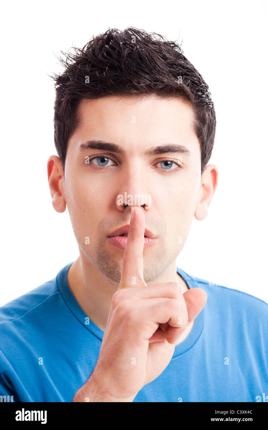 Portrait of a young man asking for silence, isolated on white ...