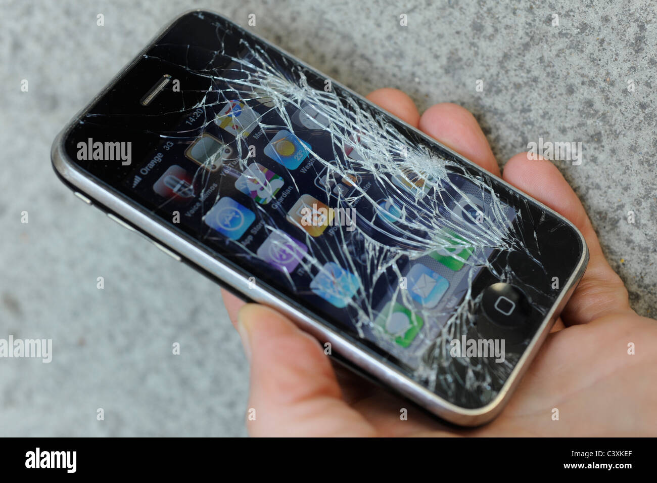 english man with a smashed iphone in the street Stock Photo - Alamy