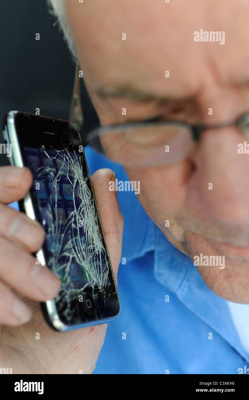 Man with smashed iphone Stock Photo - Alamy