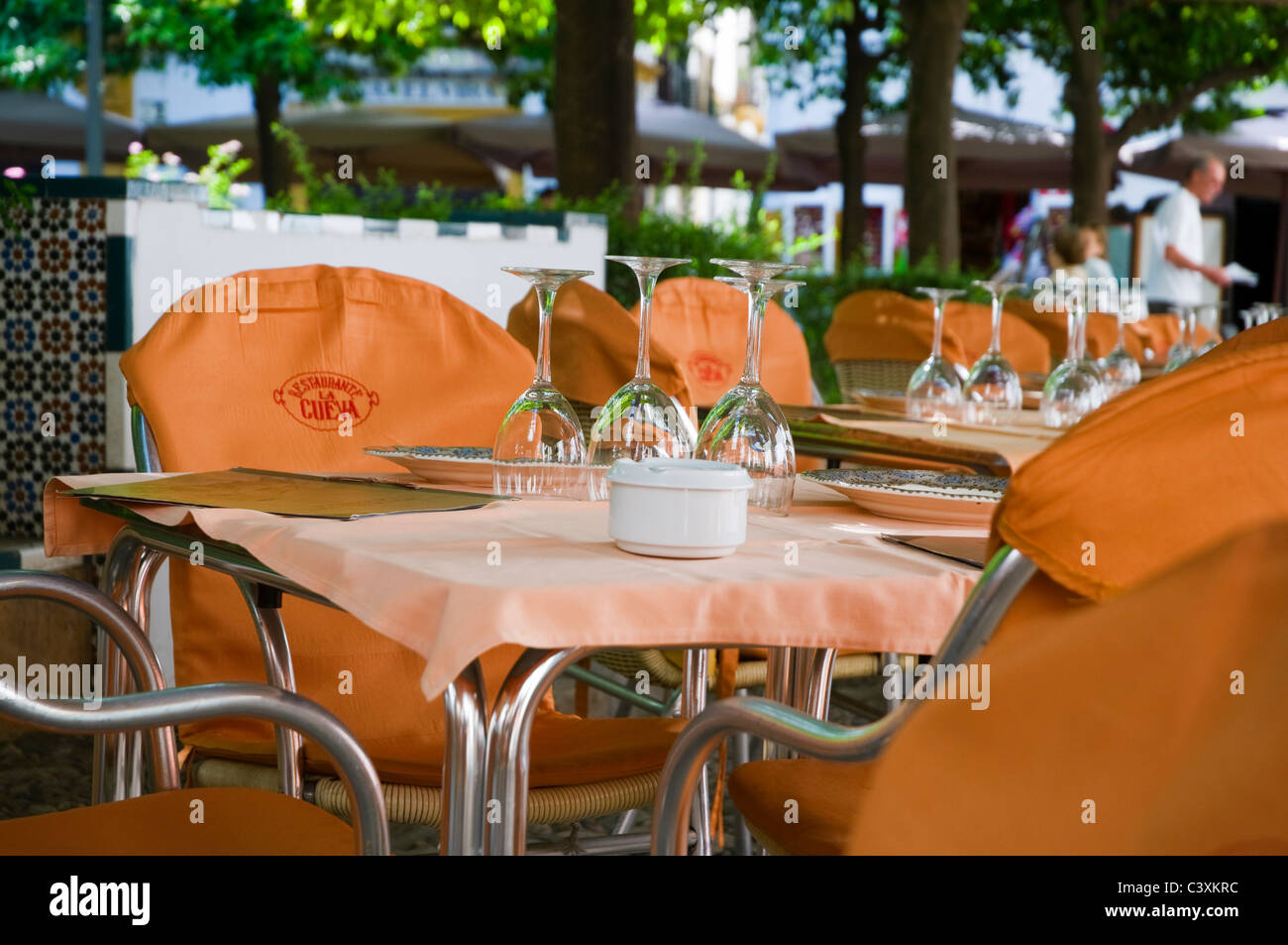 empty restaurant tables in a square in Seville, Spain. Waiting for ...