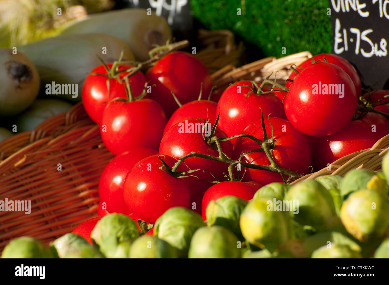 Fresh vine tomatoes for sale on a market stall in an English town Stock ...