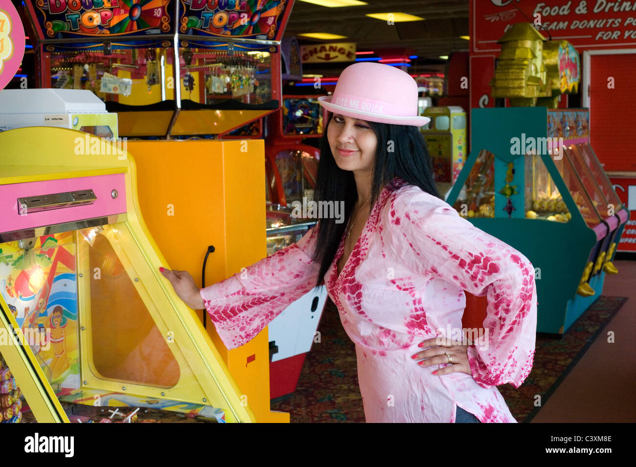 pretty woman at the seaside wearing traditional kiss me quick hat Stock ...
