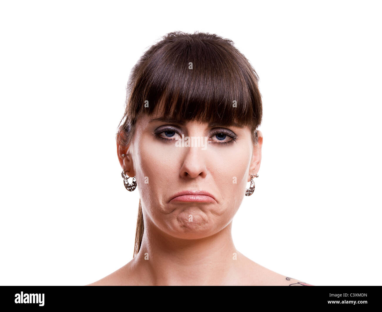 Close-up portrait of a lovely woman with a sad expression against white ...