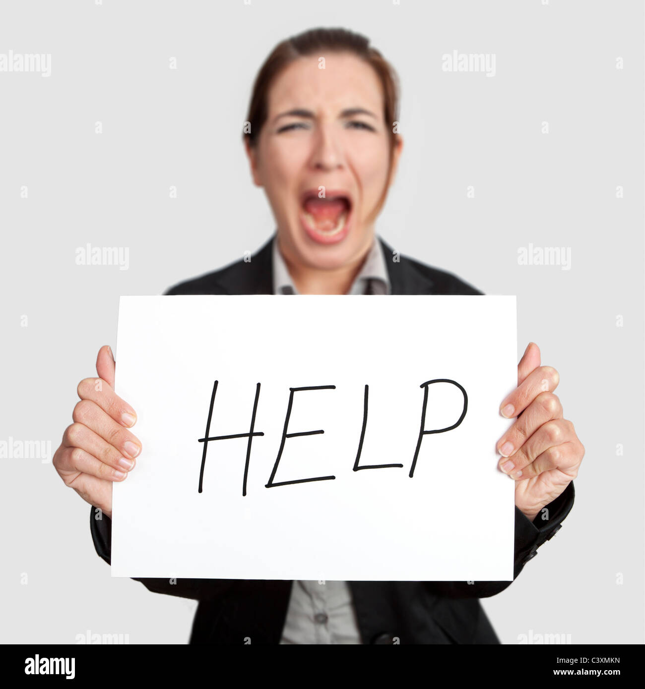 Stressed business woman imploring for help, holding a cardboard with ...