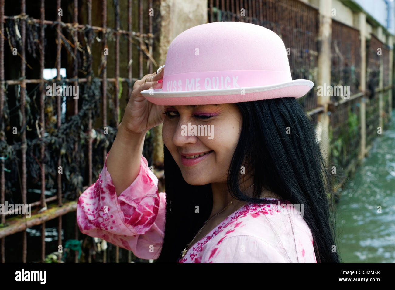 pretty woman at the seaside wearing traditional kiss me quick hat Stock ...