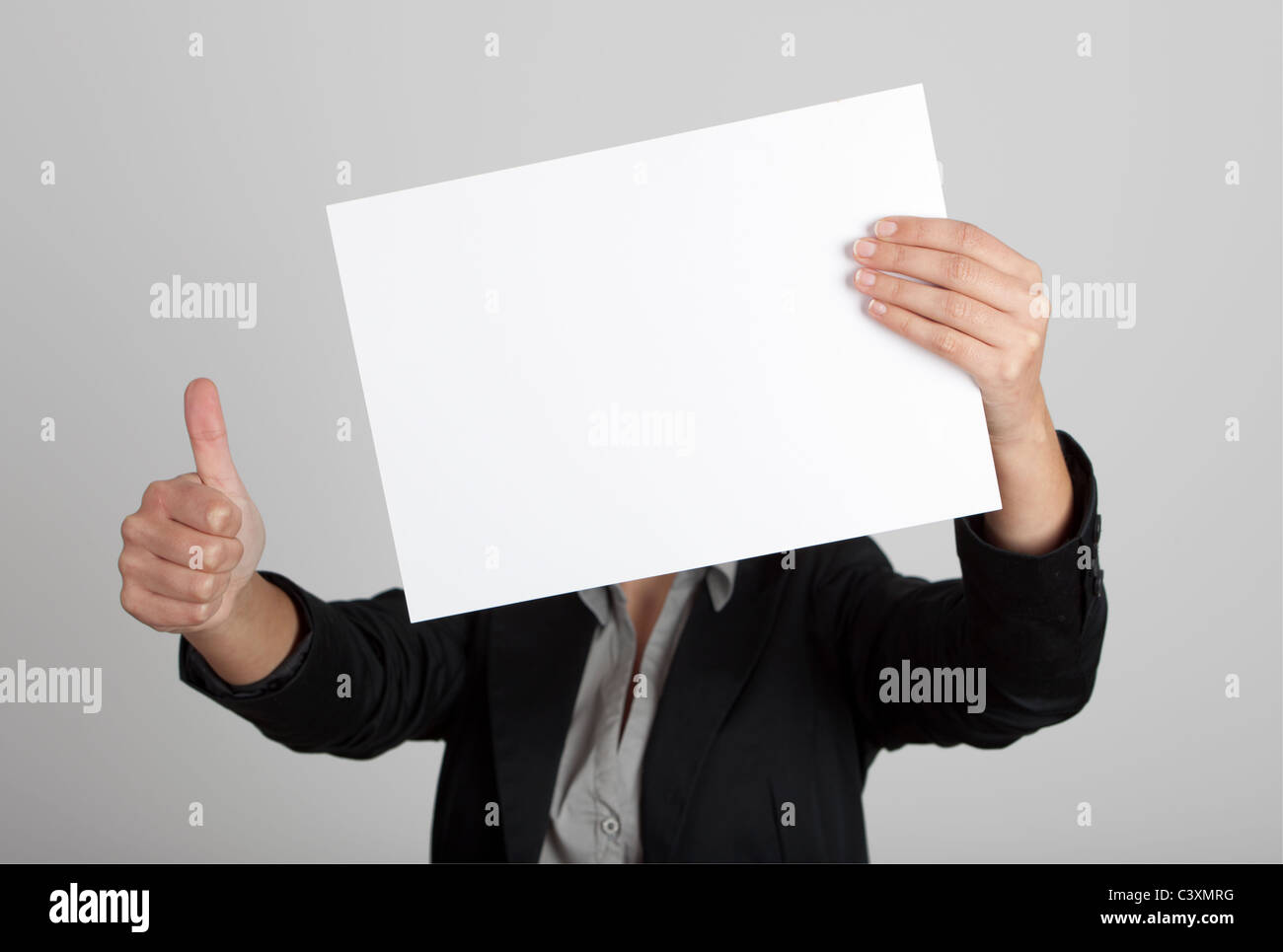 Holding up a poster in front of face hi-res stock photography and ...